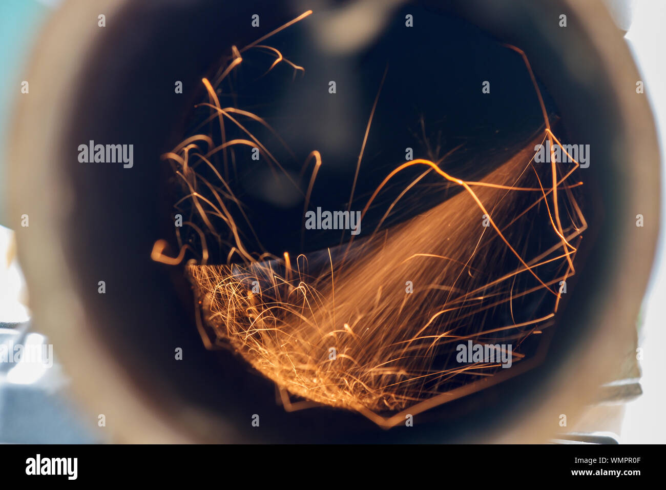 Bright Sparks tails in metal pipe with Electric Grinder Cutting Stock ...