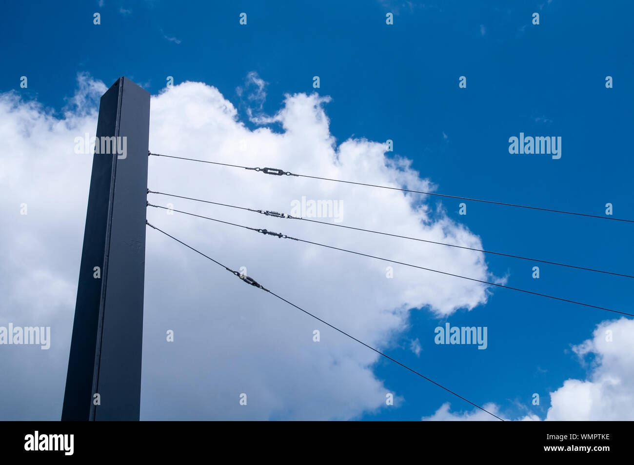 electrical power supply cables for a tramway fixed at tall metal post ...