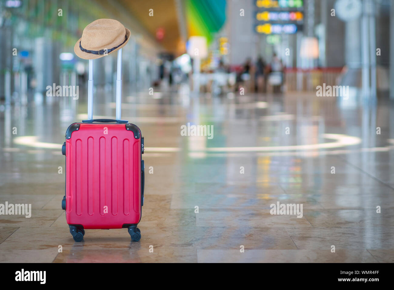 Suitcase and envelope in the aisles of an airport Stock Photo - Alamy