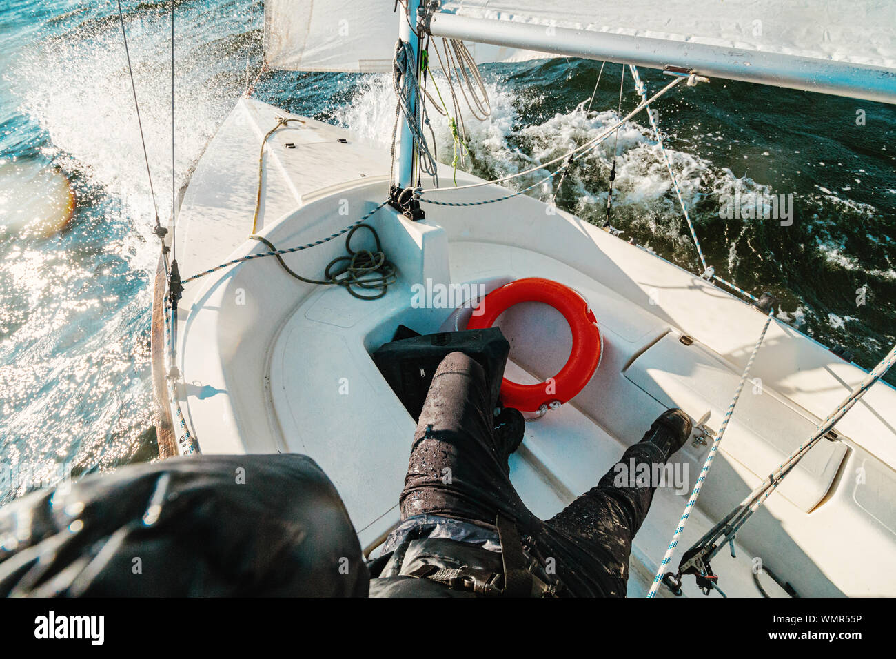 Waves spraying on the deck of a small yawl during a windy trip on the ...