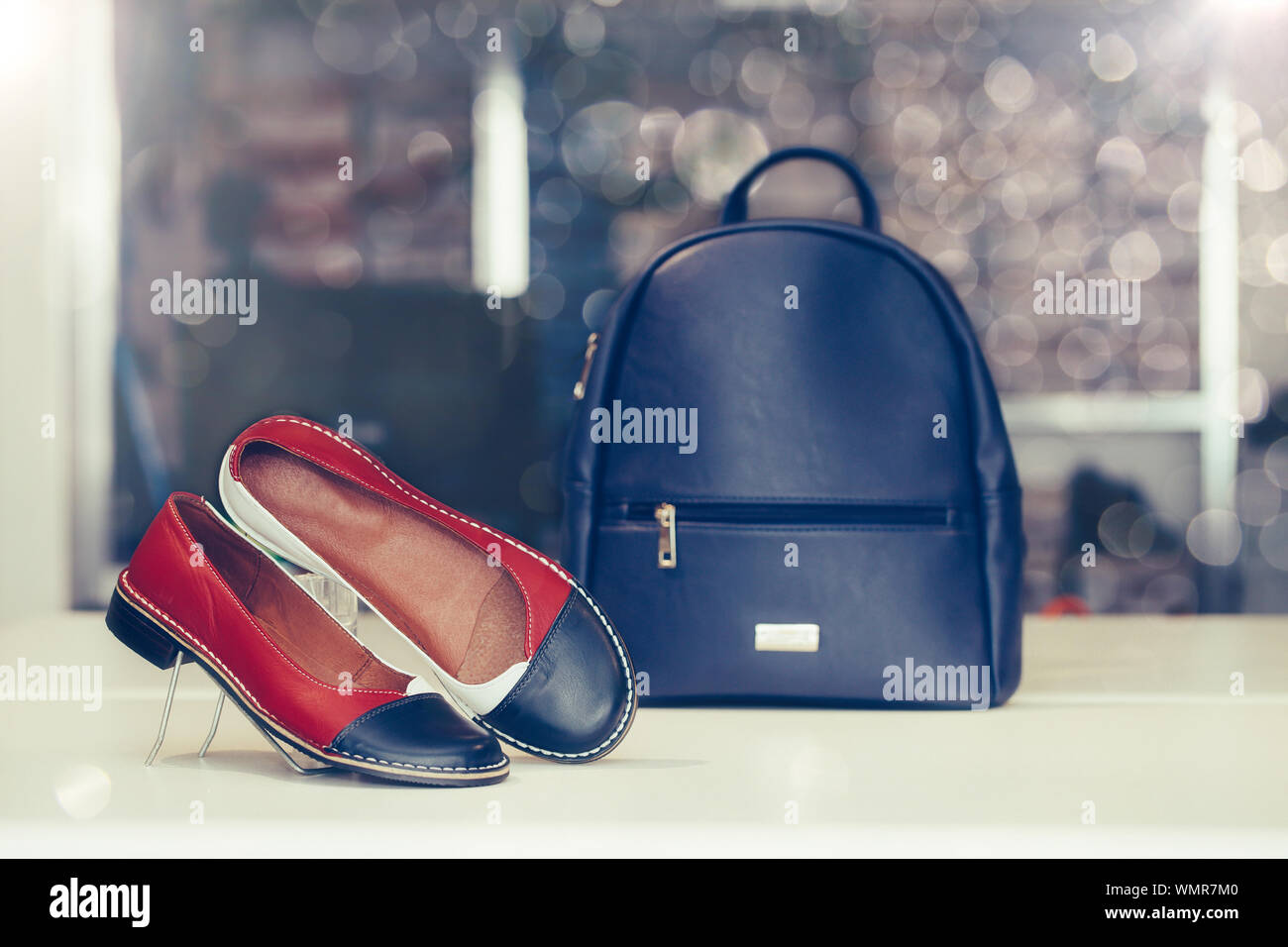Pair of stylish women leather shoes with backpack in the background in ...