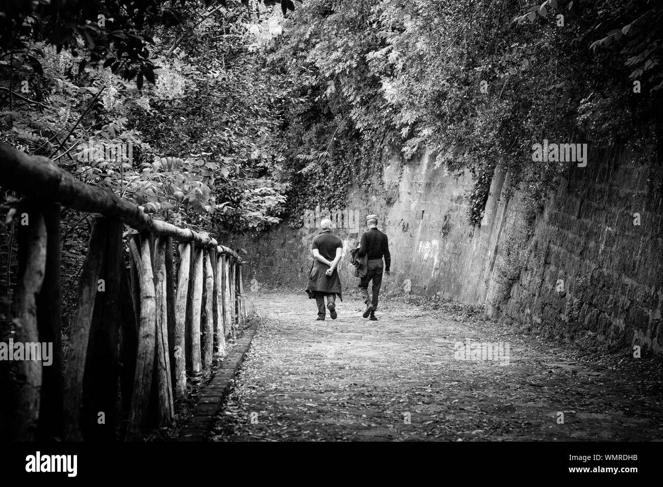 Two people walking back view Black and White Stock Photos & Images - Alamy