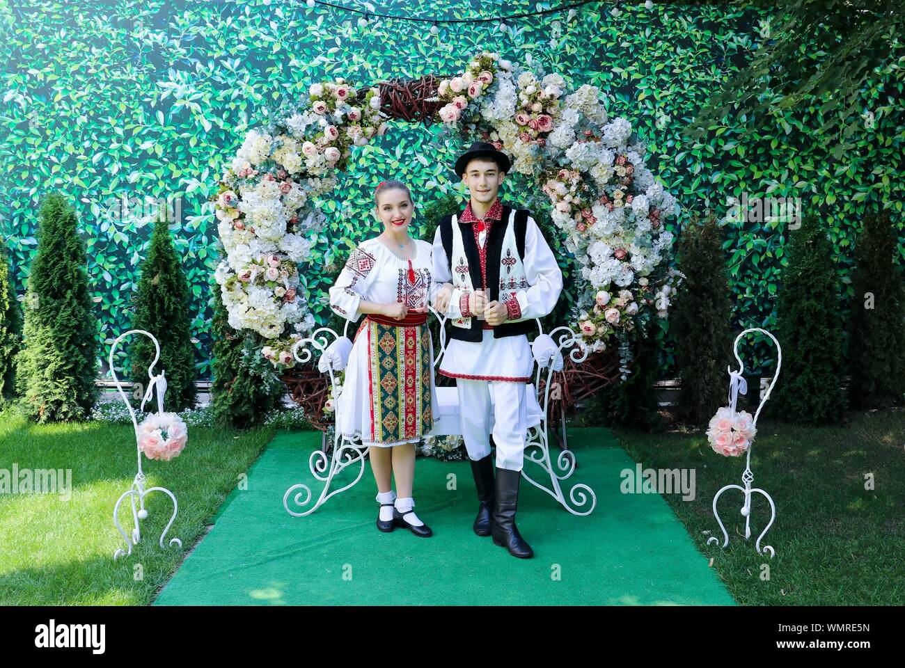 Male and a female wearing traditional Moldavian clothes standing near ...