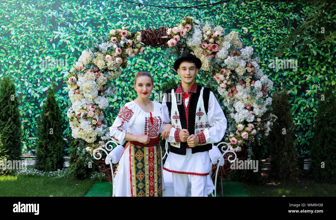 Male and a female wearing traditional Moldavian clothes standing near ...