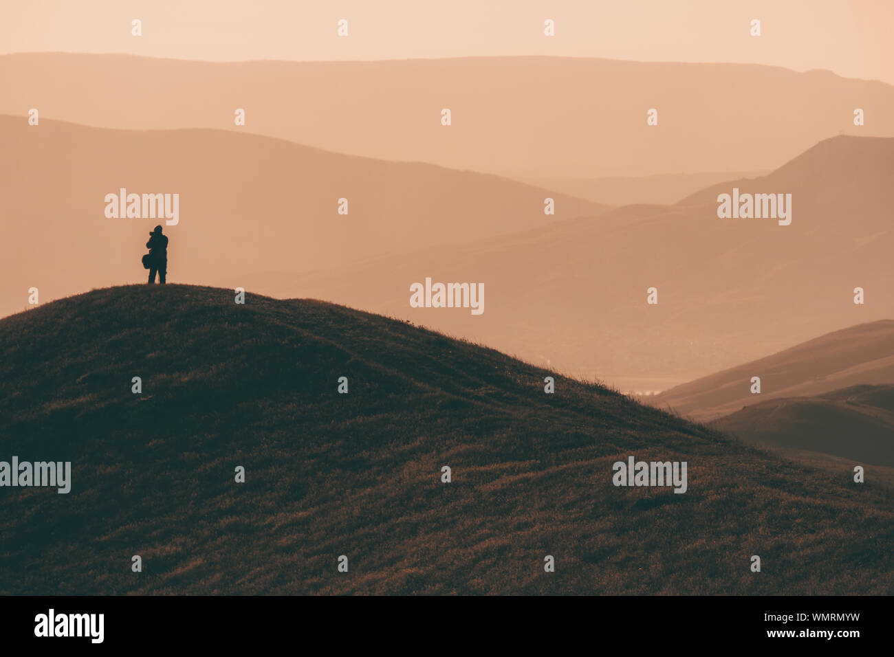 Young standing man with backpack. Hiker on the stone on the seashore at ...