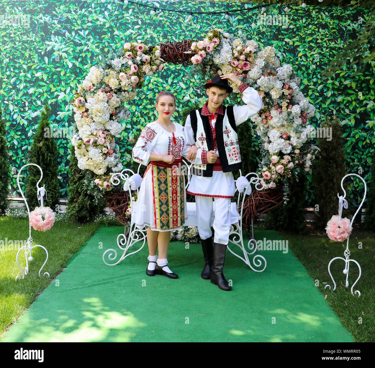 Male and a female wearing traditional Moldavian clothes standing near ...