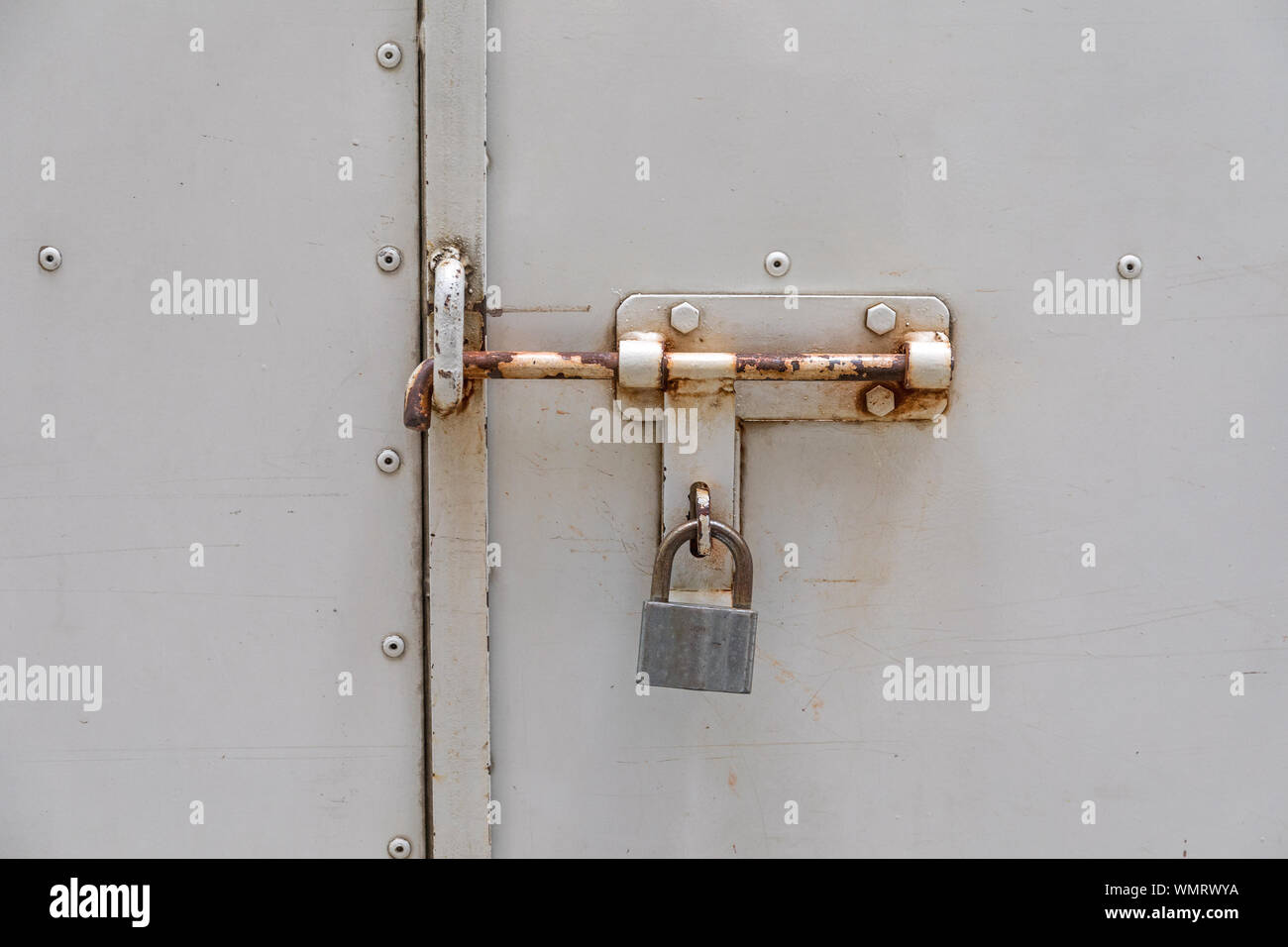 Bolt Lock With Locked Padlock at Metal Door Stock Photo - Alamy