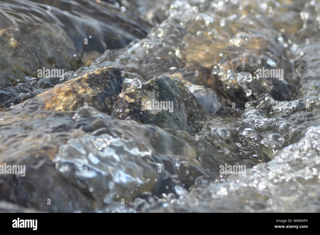 Stones in the river. Fast flowing water. Refreshing mountain river ...