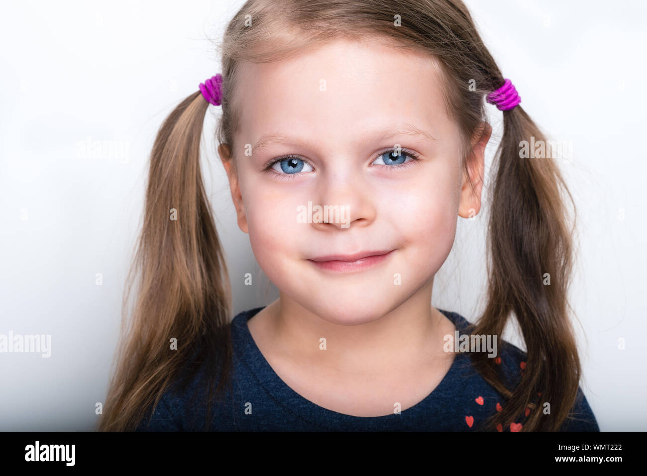 Pretty happy little girl isolated Stock Photo - Alamy