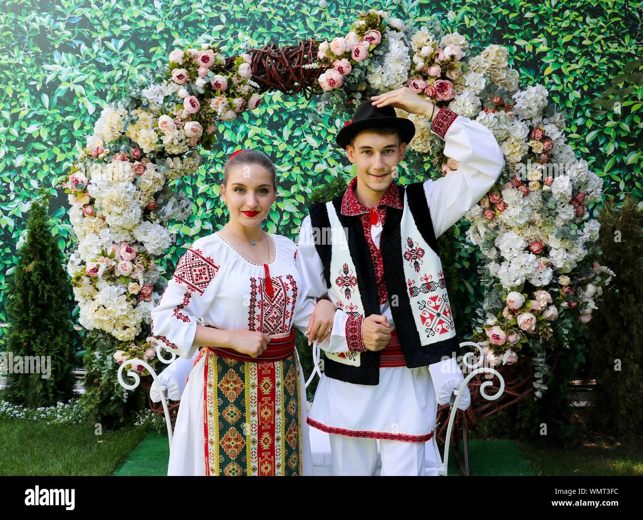 Male and a female wearing traditional Moldavian clothes standing near ...