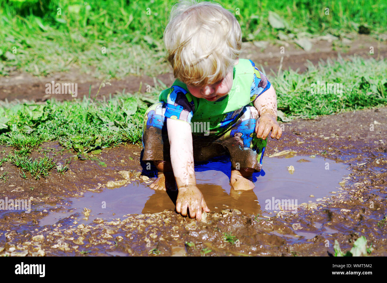Boys playing in mud hi-res stock photography and images - Alamy