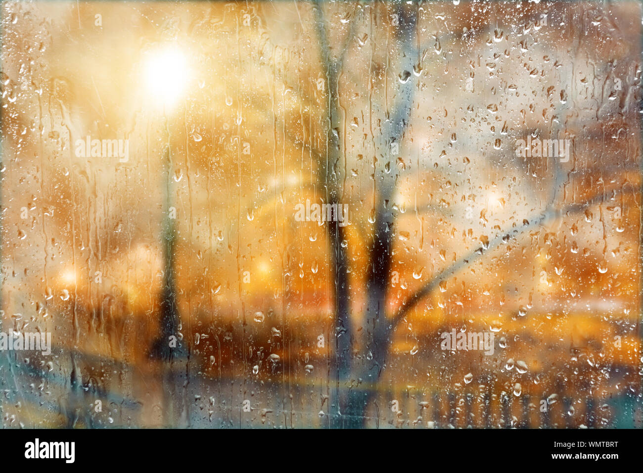 Abstract background of night city street raining through the window ...