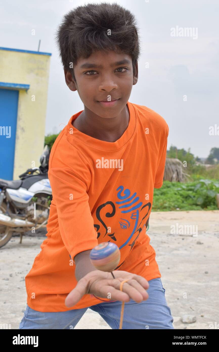 Boy playing with spinning top hi-res stock photography and images - Alamy