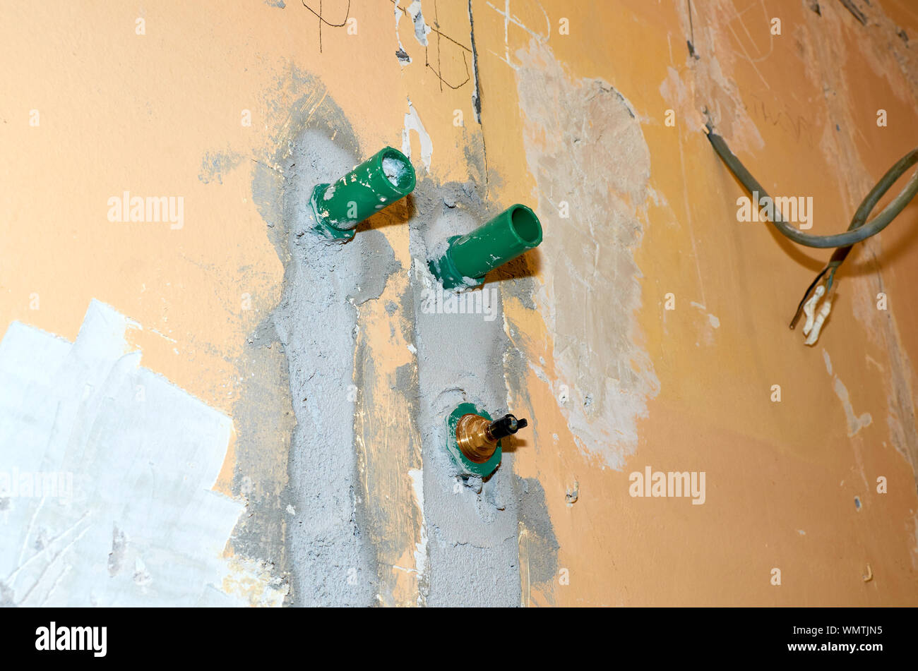 Newly installed water pipes in a wall during renovation works in an ...