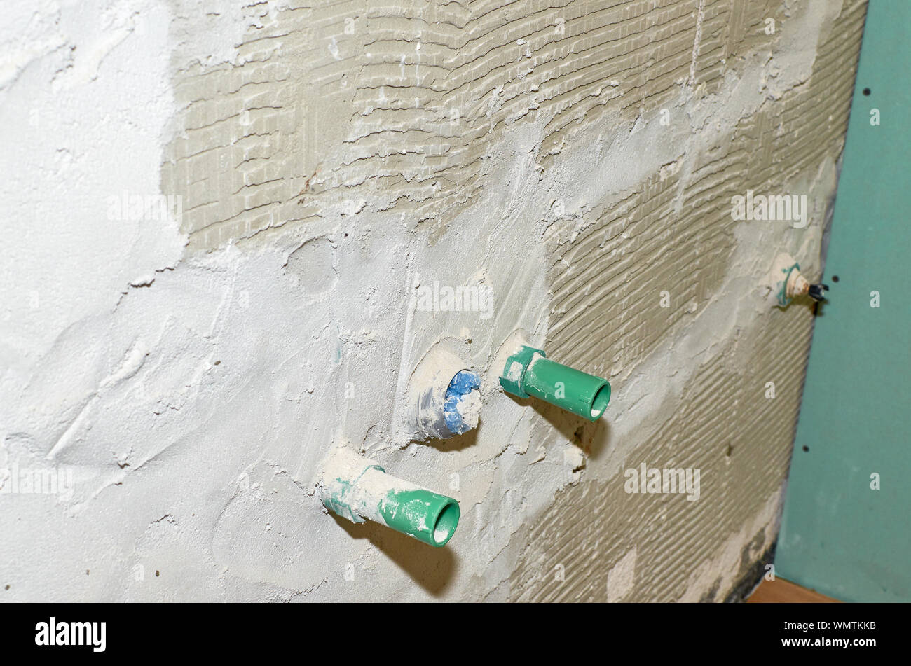 Newly installed water pipes in a wall during renovation works in an ...