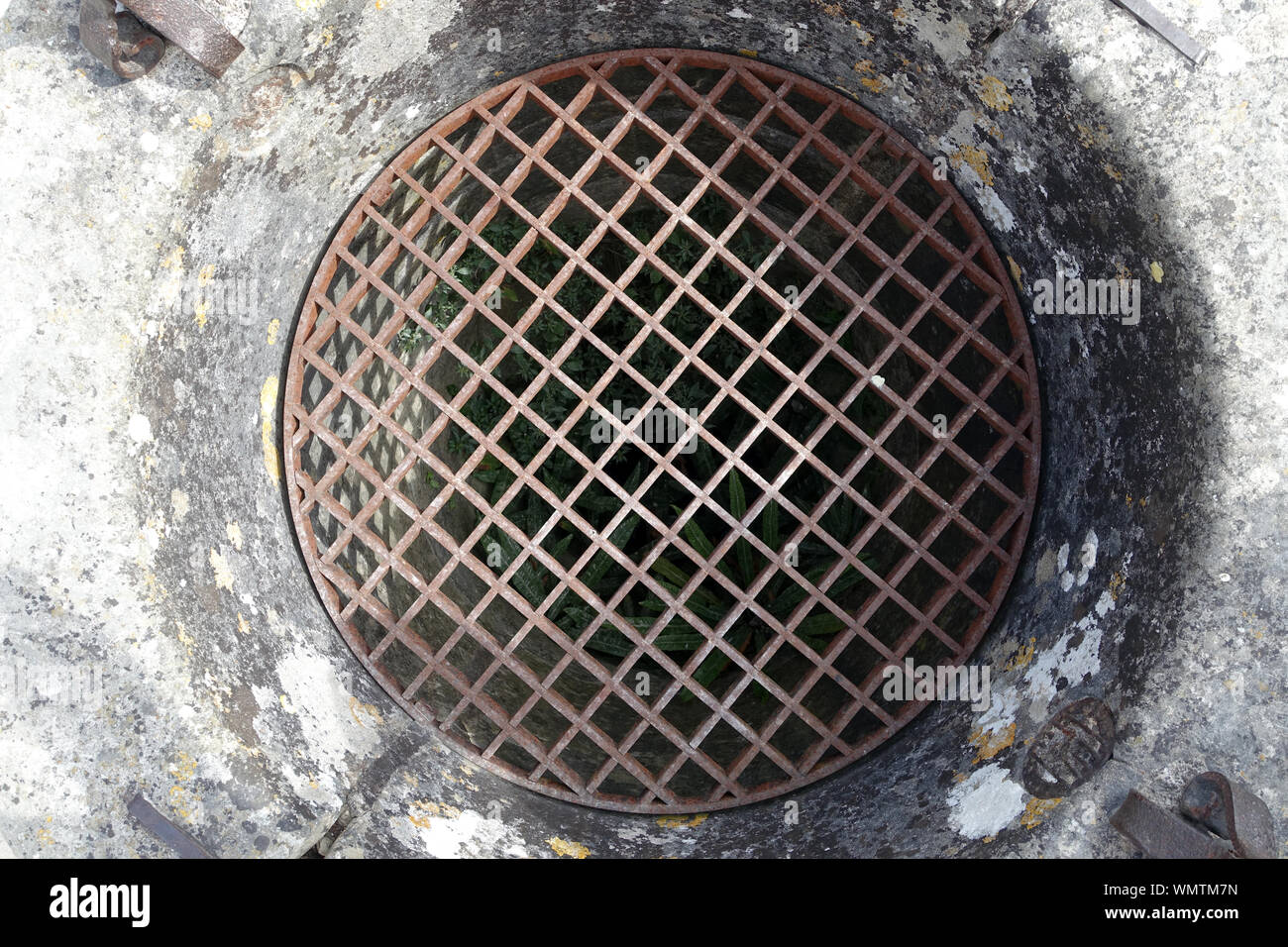 metal grill covering an old stone well Stock Photo - Alamy