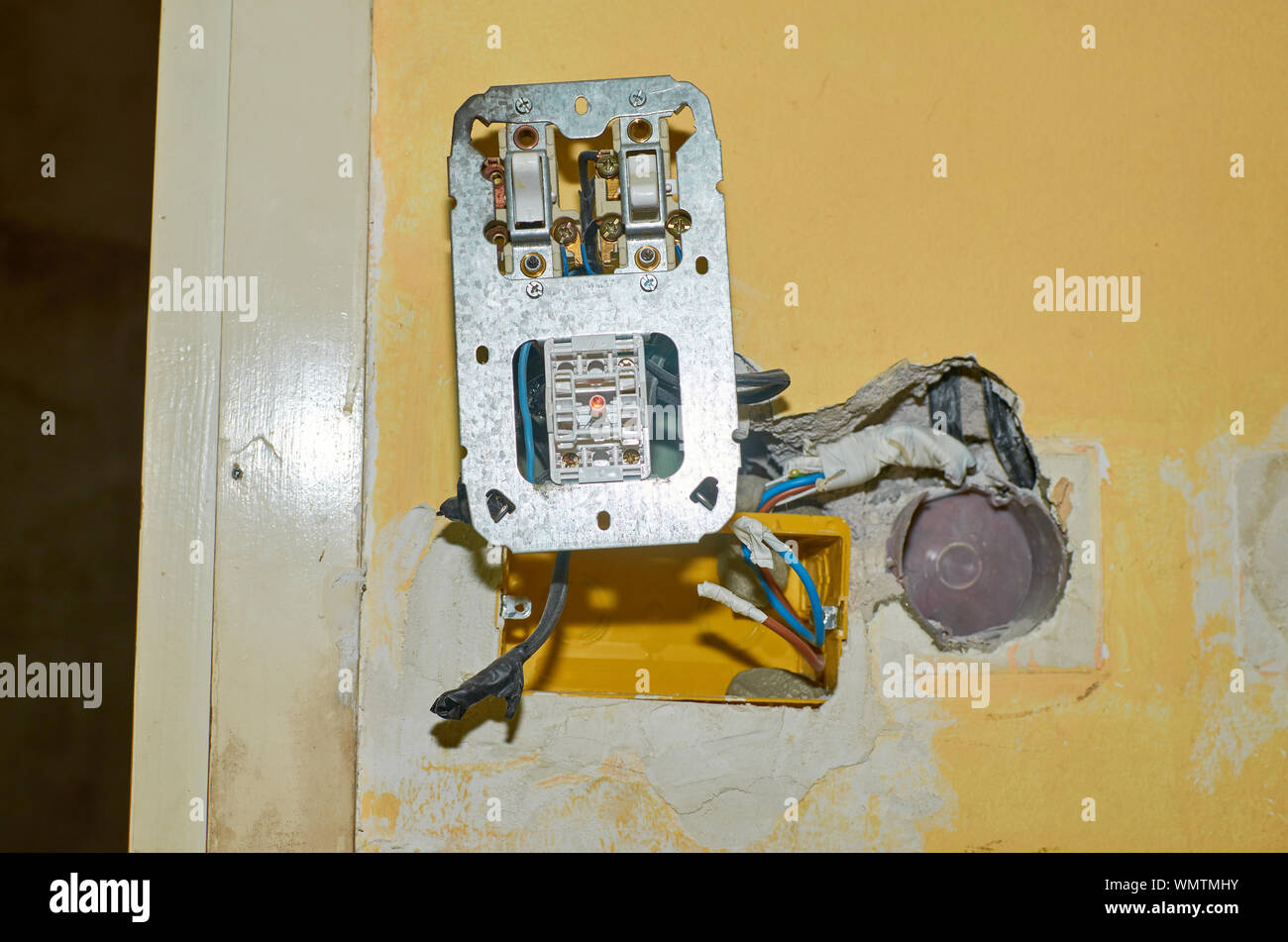 Installation of a modular light switcher in a wall Stock Photo - Alamy