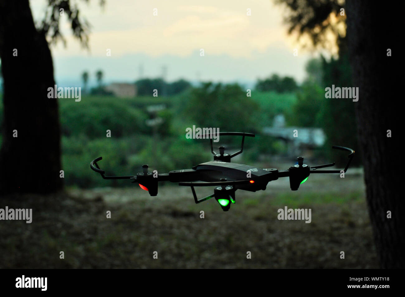 Mix of technology and nature. Air drone flying into the woods. Natural ...