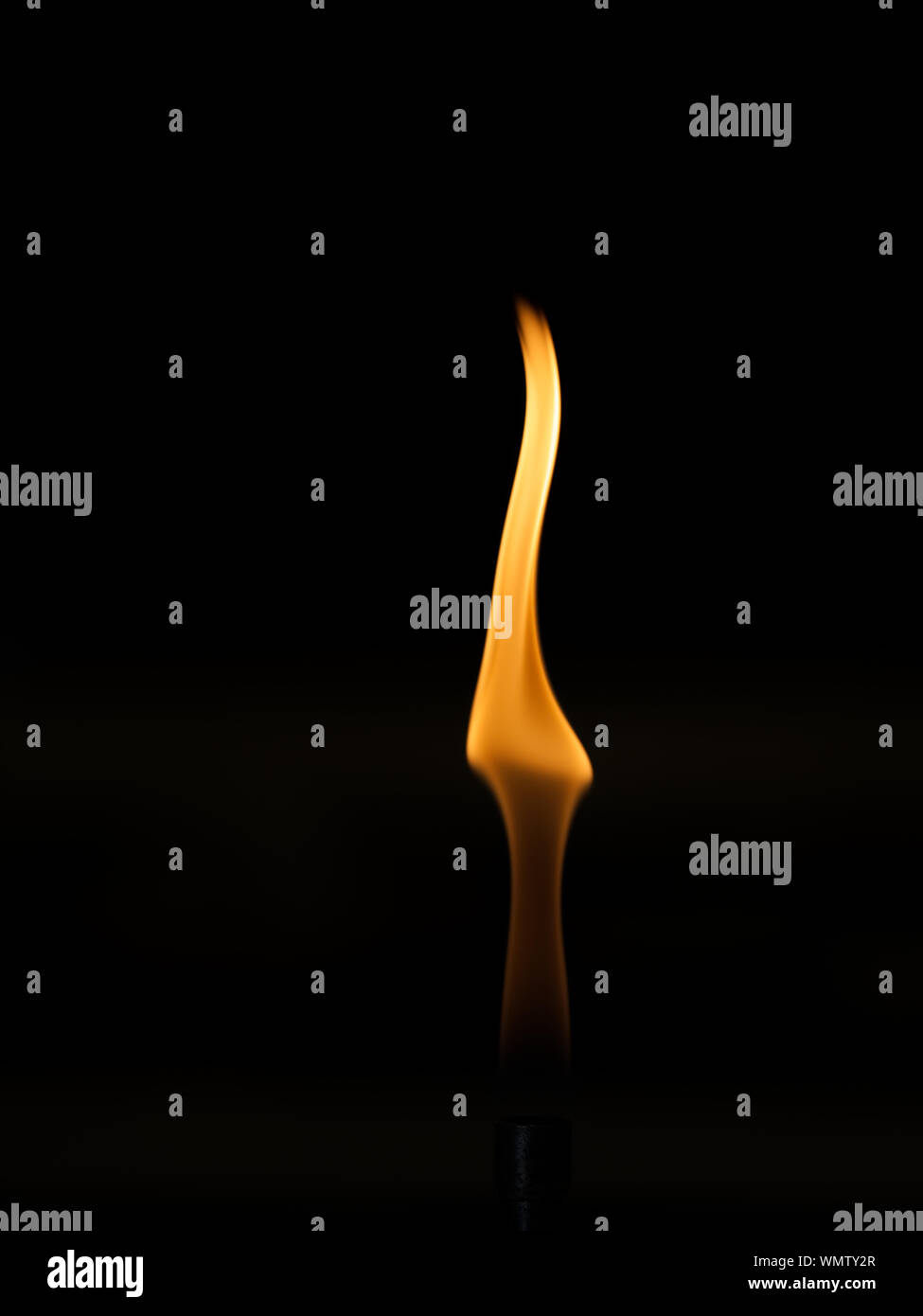 Burner flame isolated on a black background in a school science lab ...