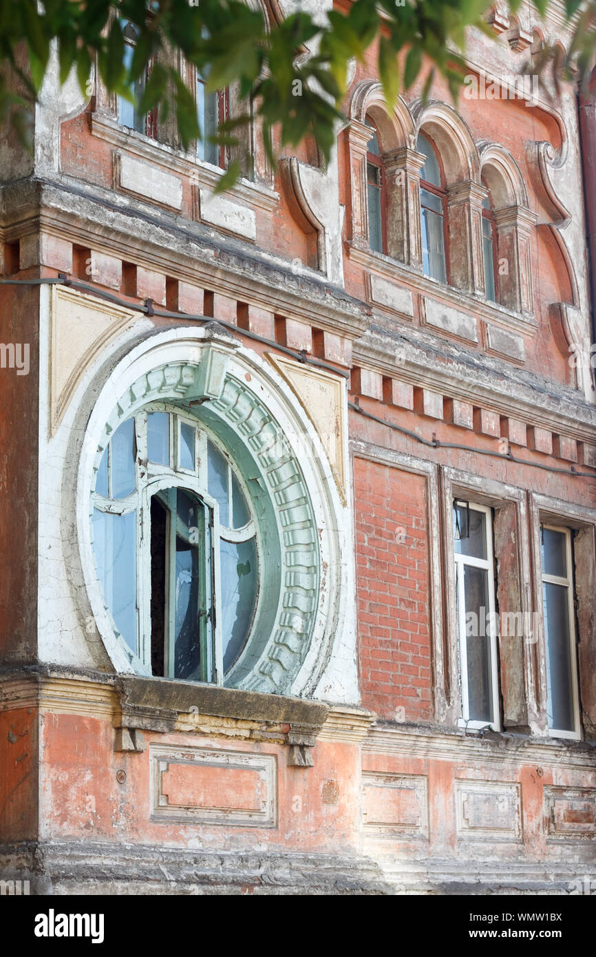 Round broken wooden window in old abandoned ruined house, background or ...