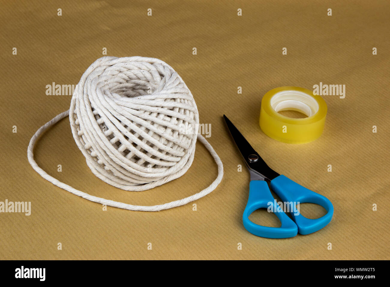 String Sticky Tape and Scissors on Brown Wrapping Paper Stock Photo - Alamy