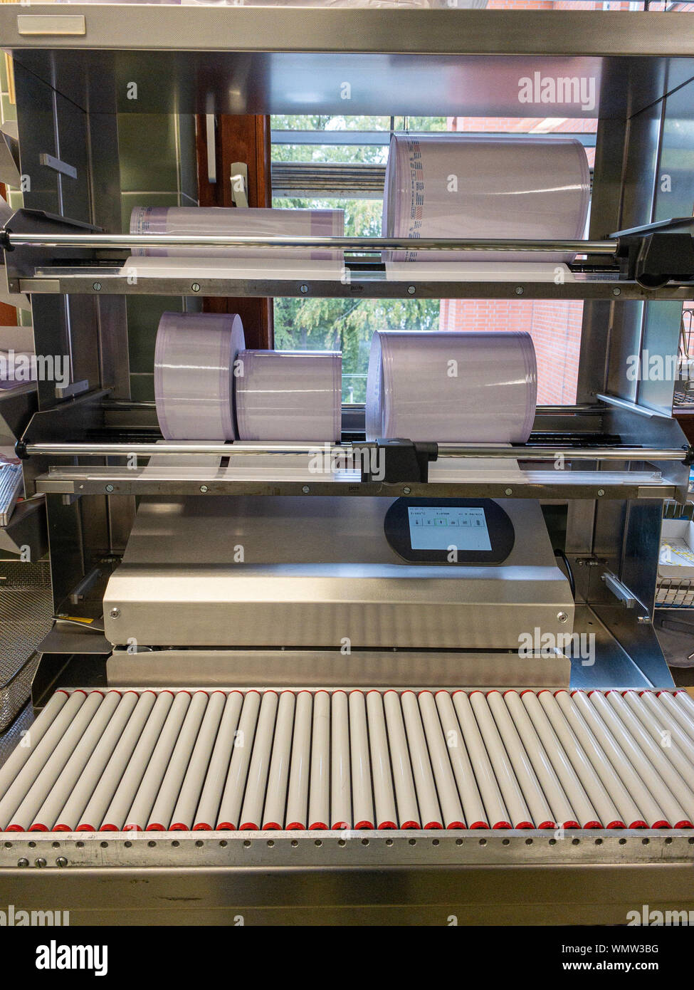 surgical instruments are shrink-wrapped at a packing station in a ...