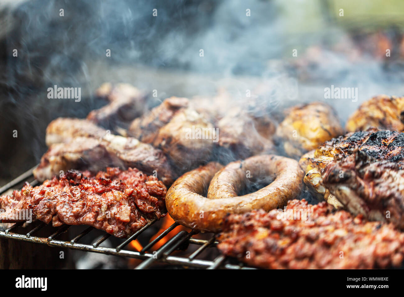 Barbeque grill mixed meat cooking on open air Stock Photo - Alamy