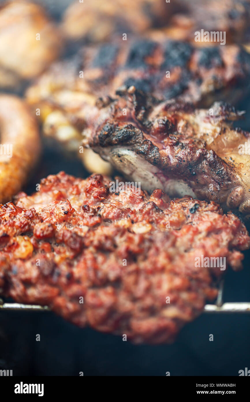 Barbeque grill mixed meat cooking on open air Stock Photo - Alamy