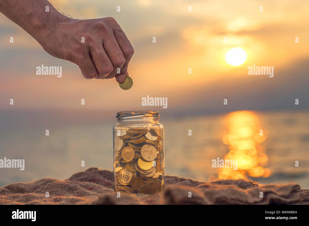 Money jar hand hi-res stock photography and images - Alamy
