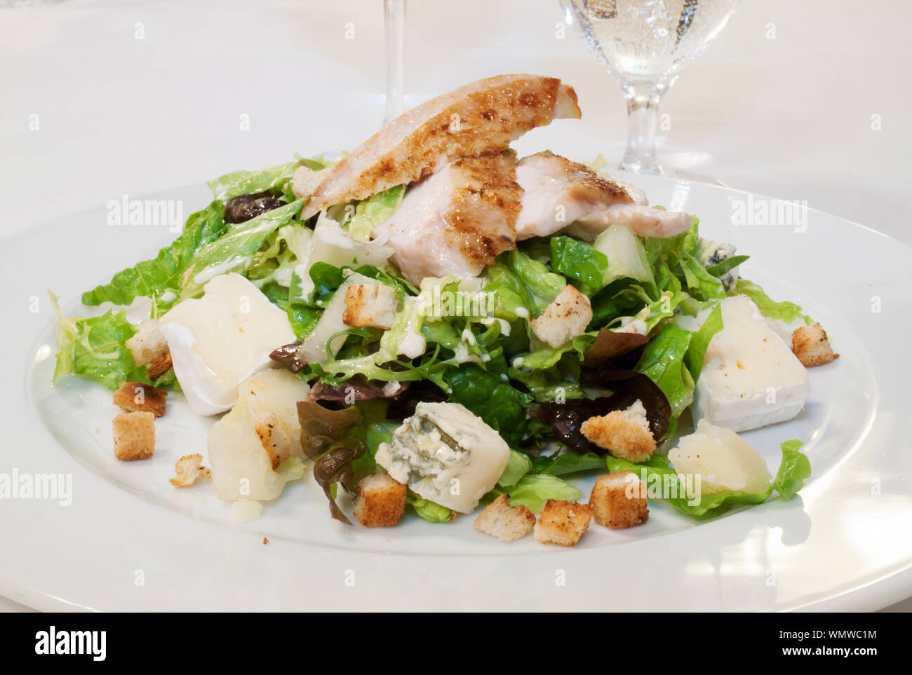 Roasted chicken leg with salad and cheese Stock Photo - Alamy