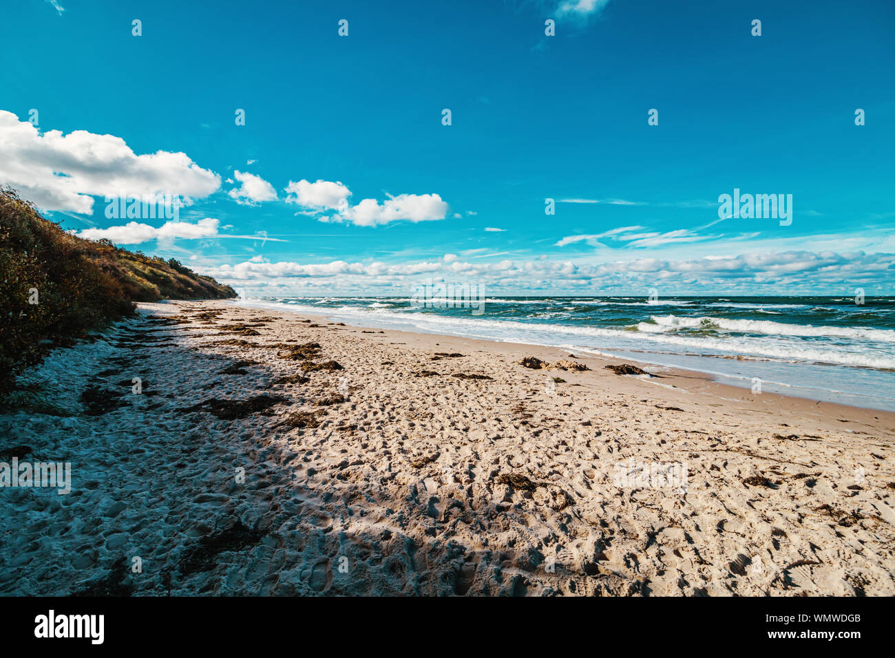 Beautiful empty beach at the coast of an Island with clouds Stock Photo ...