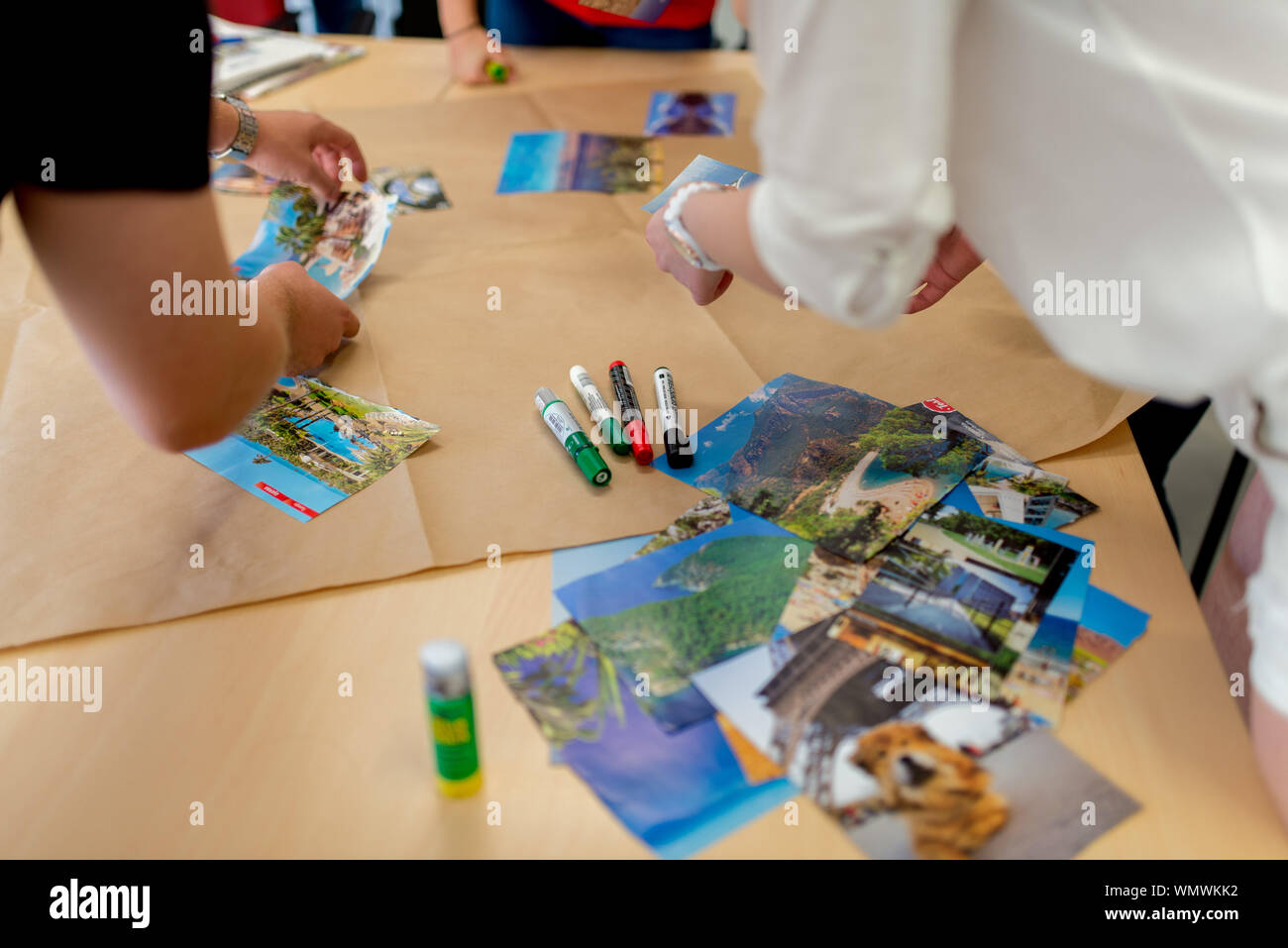 Teenagers hand writing "travel". Group classes in the travel class ...