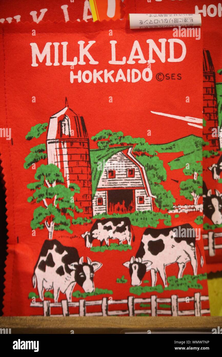 Red packaging advertising Milk Land Hokkaido in Japan showing cows and ...