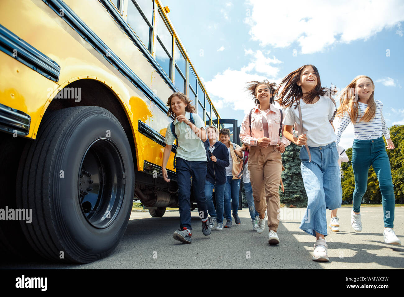 Group of children classmates running from school bus going back home ...