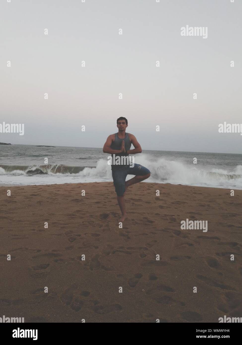 Young man yoga tree pose hi-res stock photography and images - Alamy