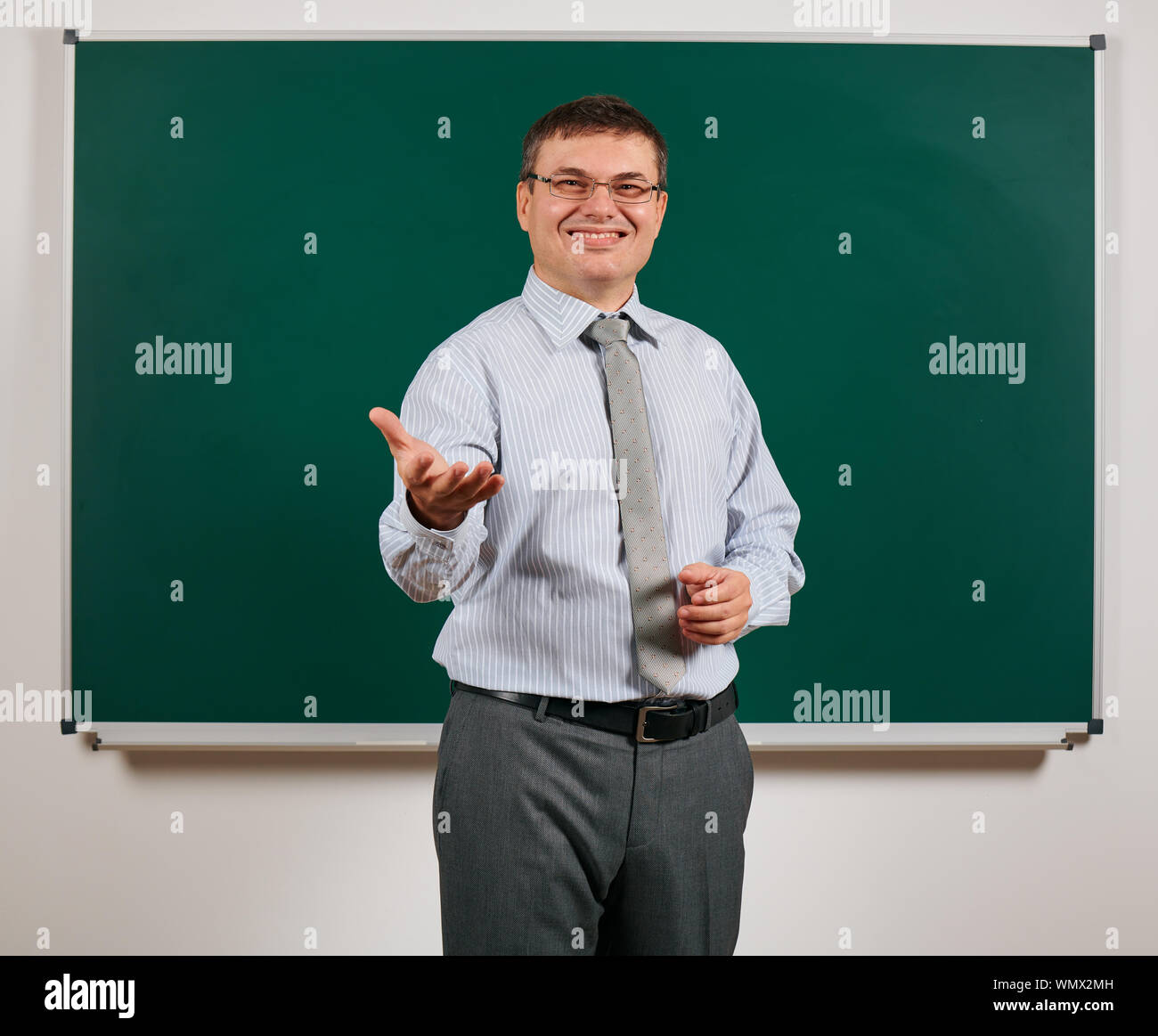 Portrait of a man dressed as a school teacher in business suit, posing ...