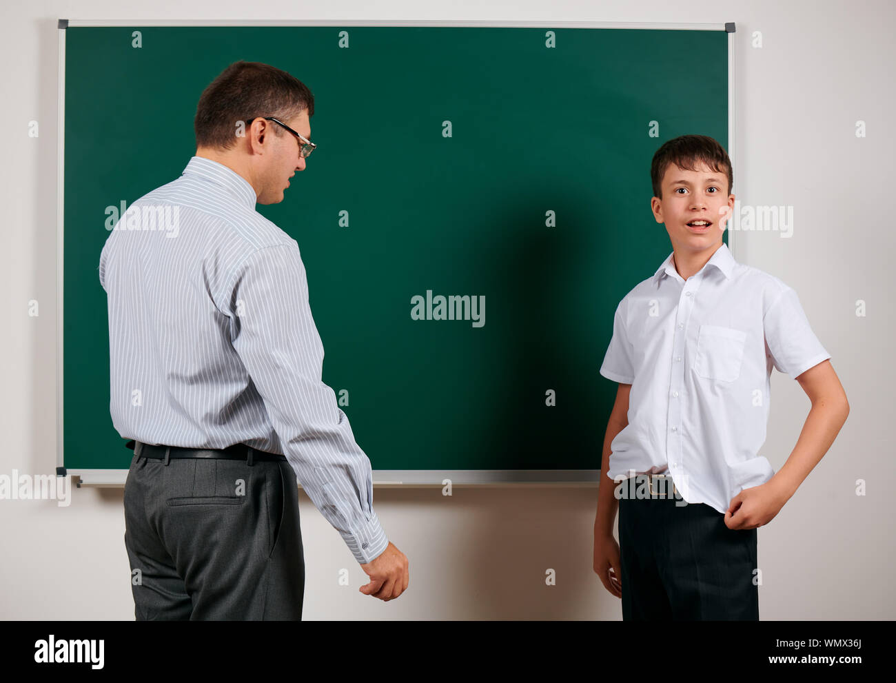Portrait of a teacher and funny schoolboy with low discipline, poor ...