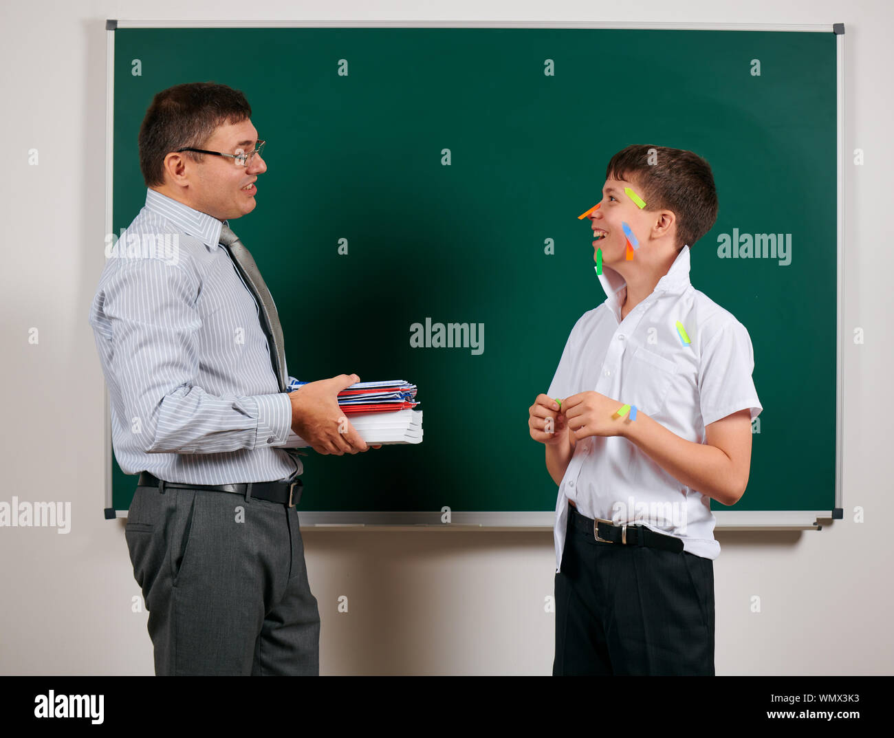 Portrait of a teacher and funny schoolboy with low discipline, poor ...