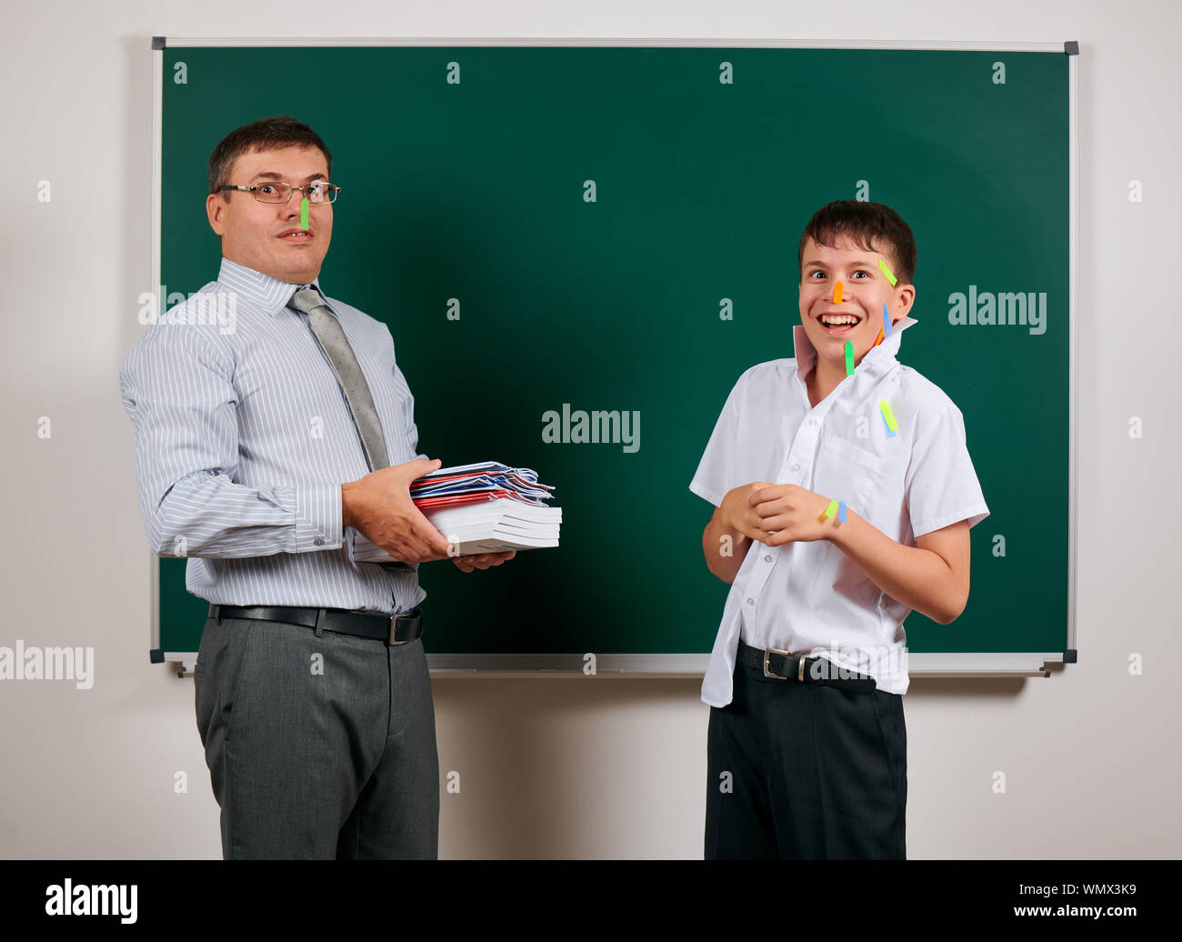 Portrait of a teacher and funny schoolboy with low discipline, poor ...
