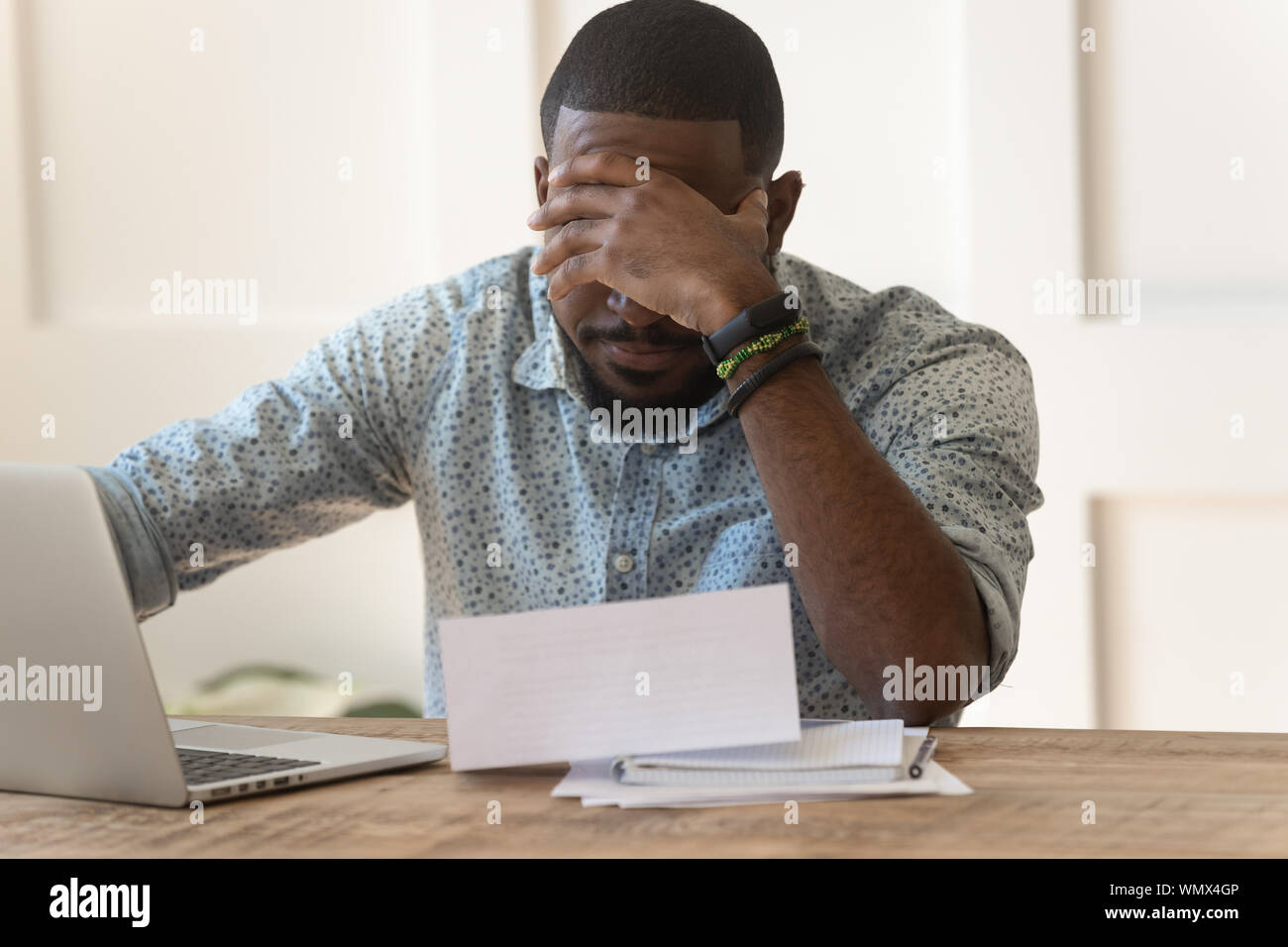 Stressed upset african american reading bad news in letter Stock Photo ...