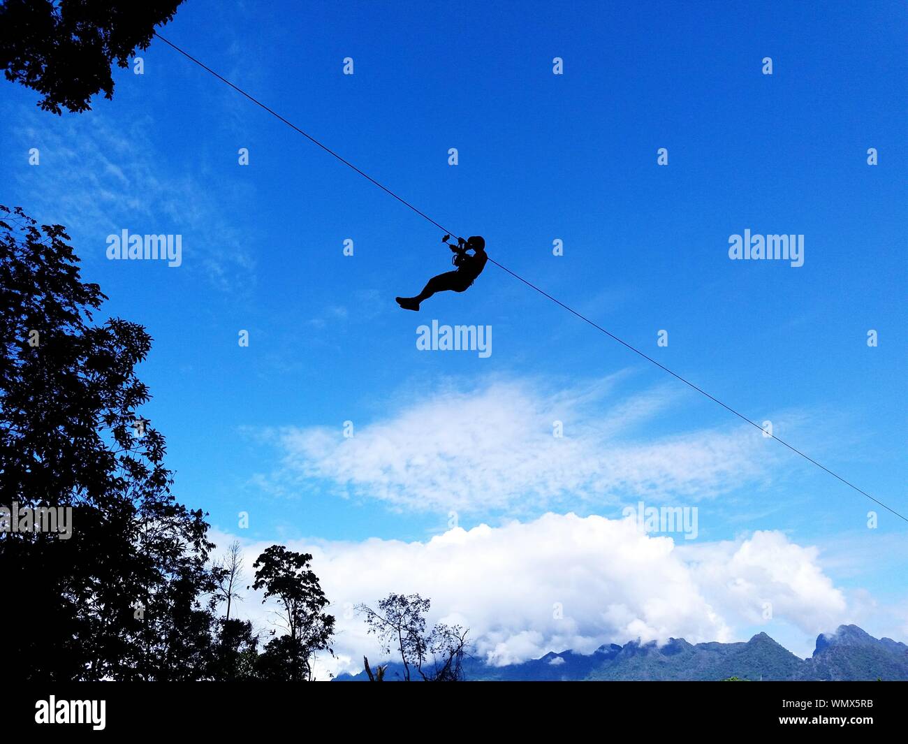 Person zip lining hi-res stock photography and images - Alamy