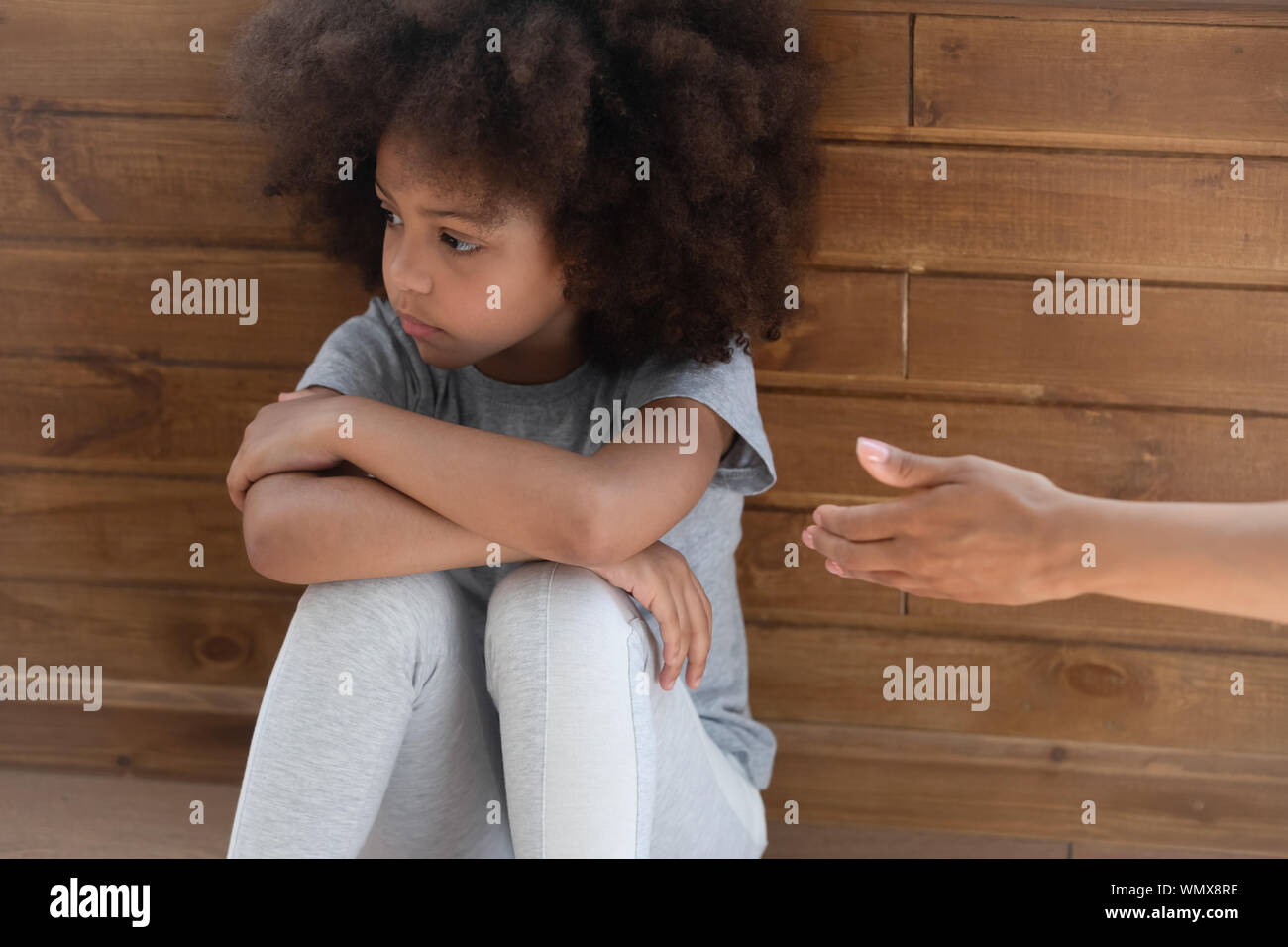 Upset african american little girl ignoring lent mommys hand Stock ...