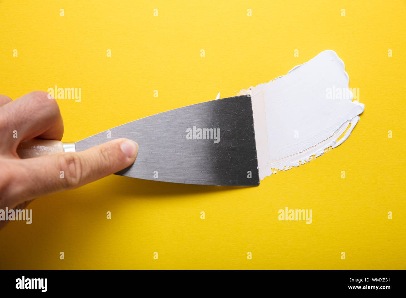 Close-up Of Painter's Hand Puttied Wall Using A Paint Trowel Stock ...