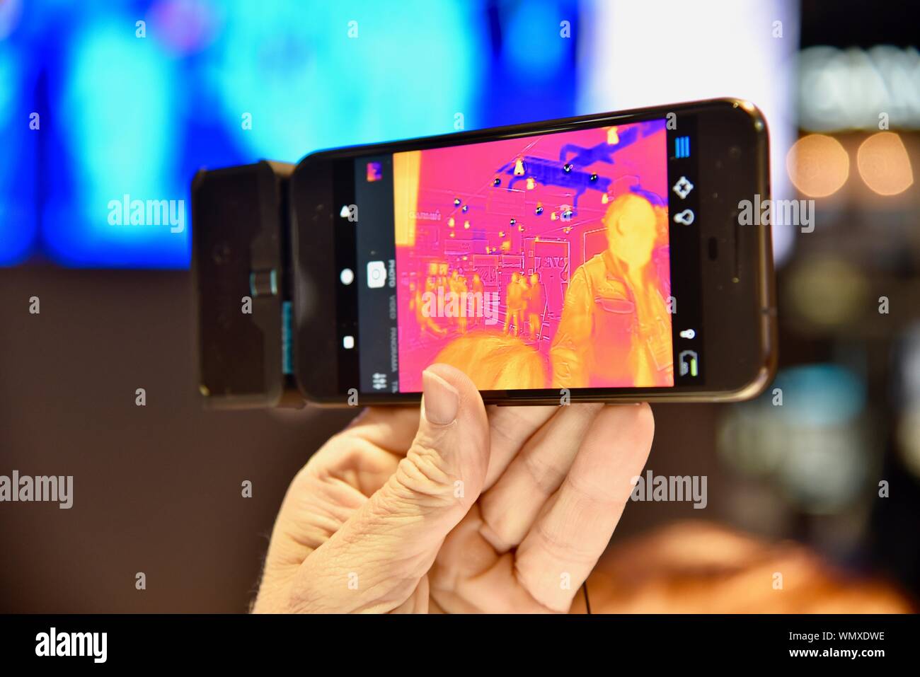 Taking photographs with a FLIR thermal infrared camera on display, with ...