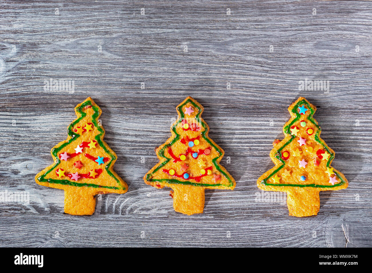 Traditional Christmas tree-shaped curly cookies on a rustic table ...