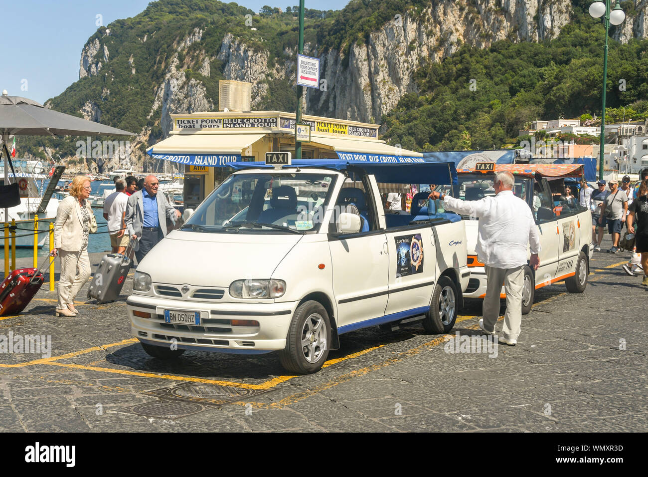 ISLE OF CAPRI, ITALY - AUGUST 2019: People with luggage at the taxi ...