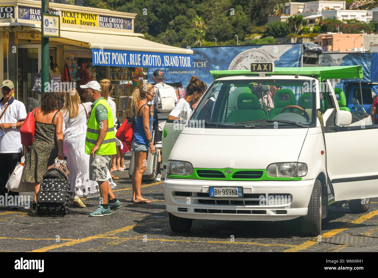 ISLE OF CAPRI, ITALY - AUGUST 2019: People with luggage at the taxi ...