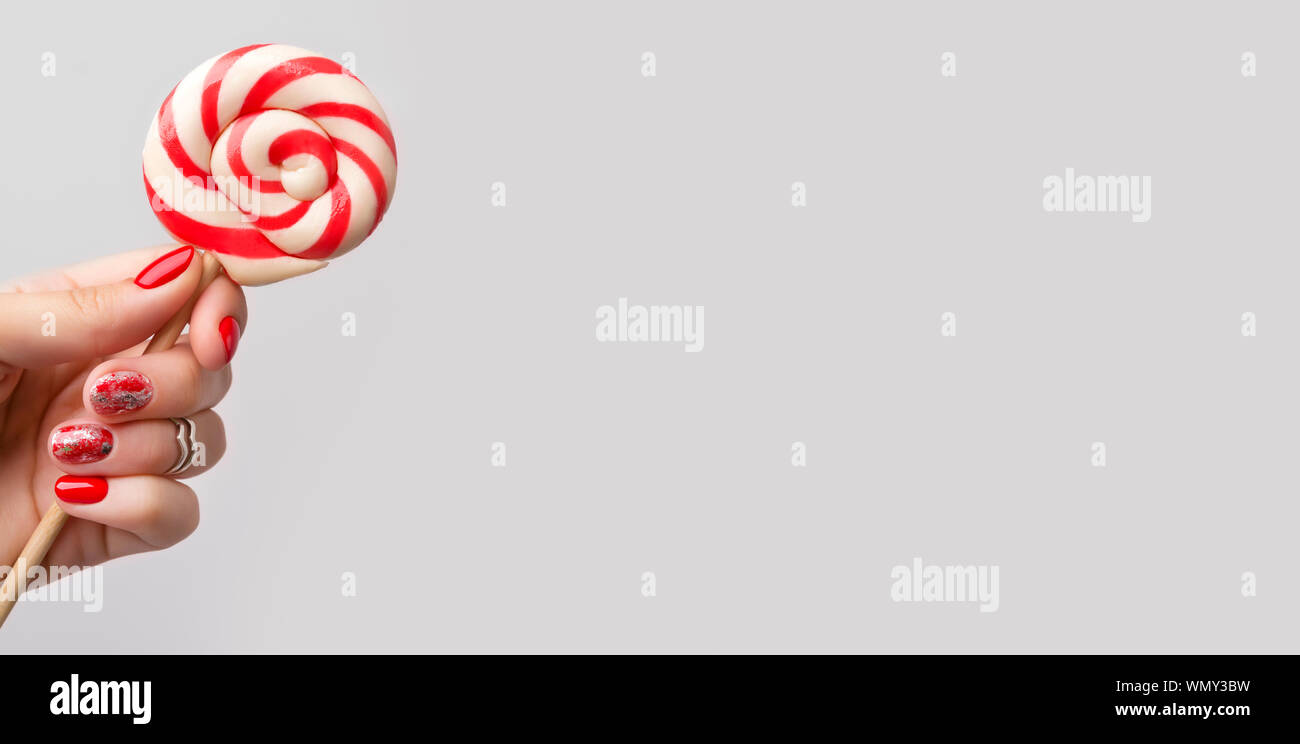 Hand holding candy hi-res stock photography and images - Alamy