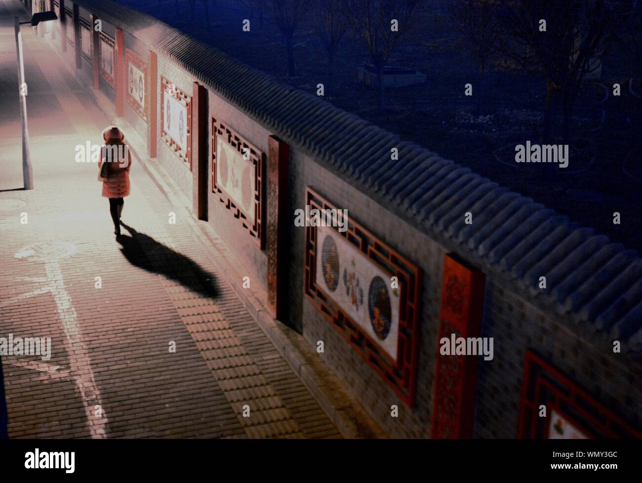 Woman walking high angle night hi-res stock photography and images - Alamy