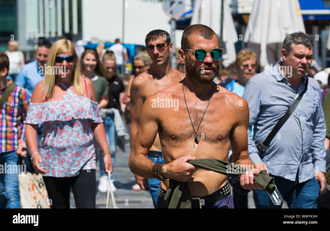 Shirtless muscly man possibly in his 30s wearing sunglasses walking ...